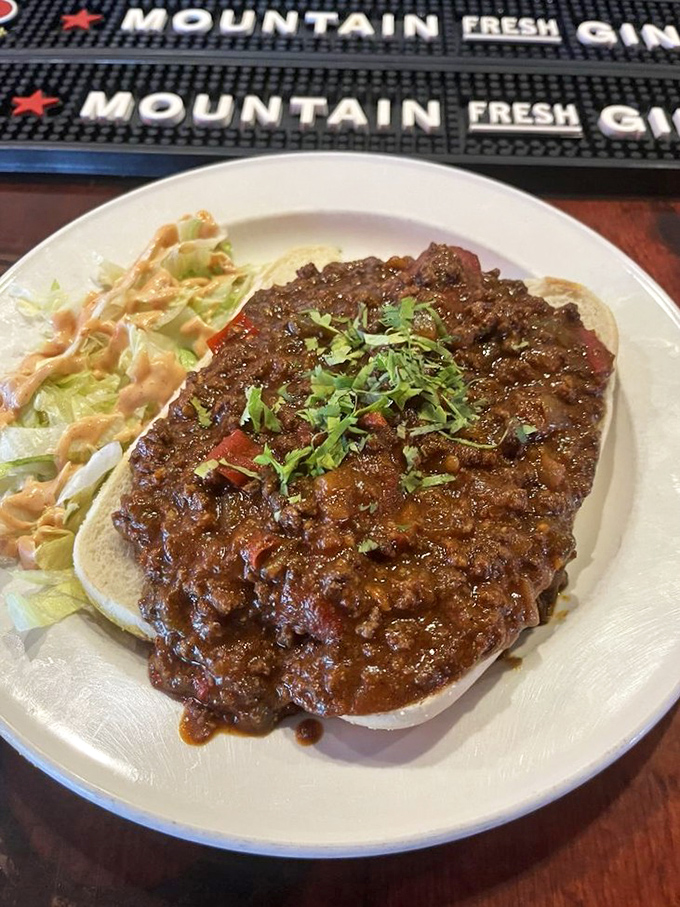 Chili so serious it demands an equally committed vessel. This open-faced sandwich doesn't just satisfy hunger&mdash;it conquers it completely.
