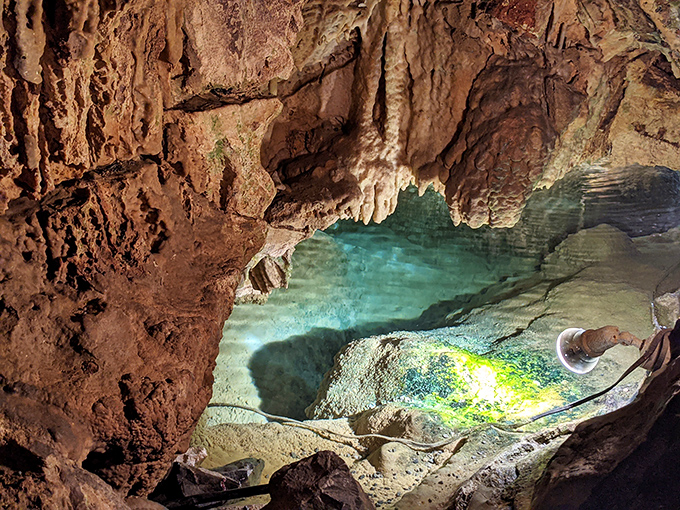Crystal-clear waters reflect the cavern ceiling like nature's own funhouse mirror, doubling the visual impact of this underground marvel.