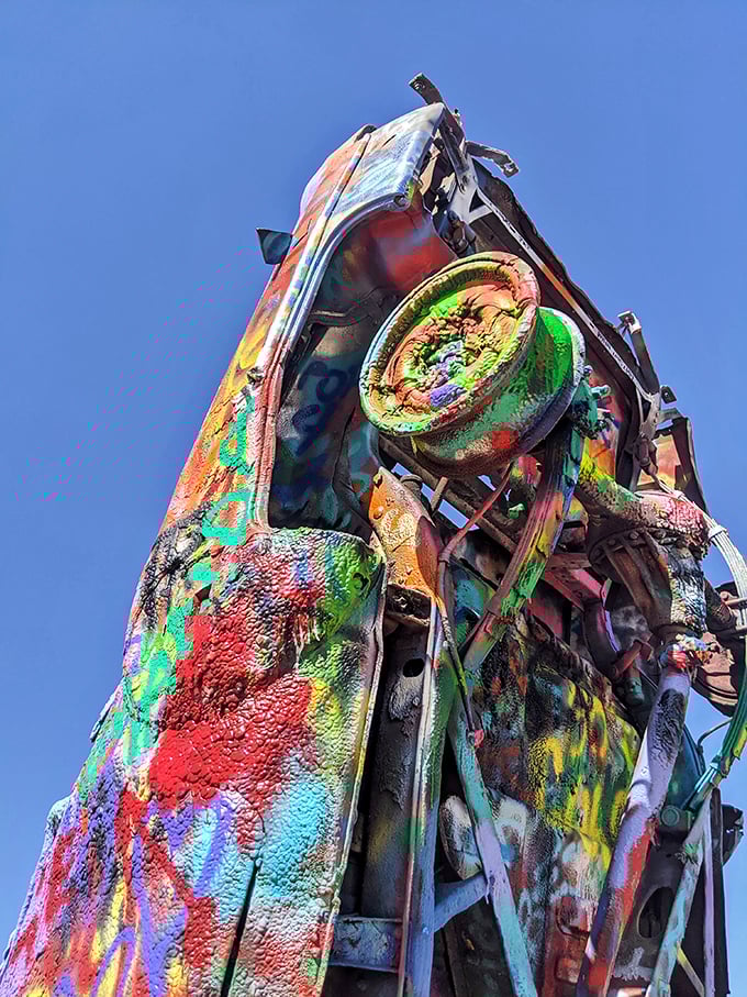 Up close, each Cadillac reveals thousands of paint layers like geological strata of artistic expression. Every inch tells a different visitor's story.