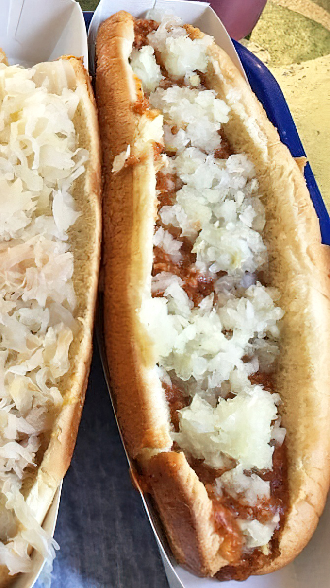 Simplicity perfected: a soft bun cradling a hot dog smothered in savory chili and topped with a snowfall of diced onions.