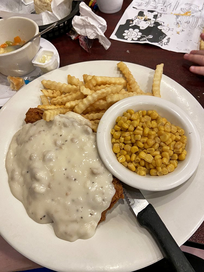 Beneath that blanket of peppery gravy lies a country fried steak with a secret mission: to make you forget every mediocre version you've ever encountered.