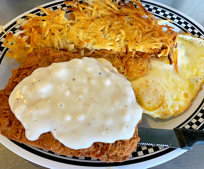 Country fried steak smothered in creamy gravy alongside crispy hash browns and sunny-side-up eggs. Heart surgeons hate this plate, but your soul will thank you.