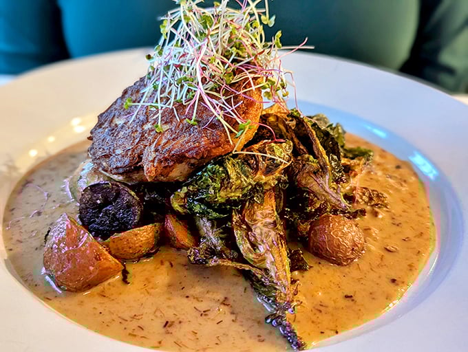 The star of the show: a perfectly seared crab cake nestled among roasted vegetables. That sauce isn't just a condiment—it's liquid gold worth bottling.