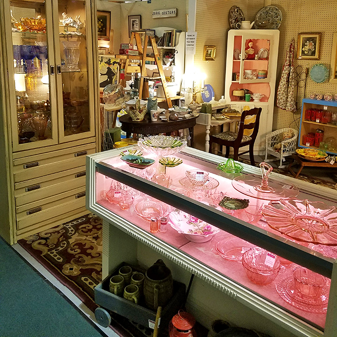 Pink Depression glass gleams under display lights like jewels. These dishes have served more Sunday dinners than we've had hot breakfasts.