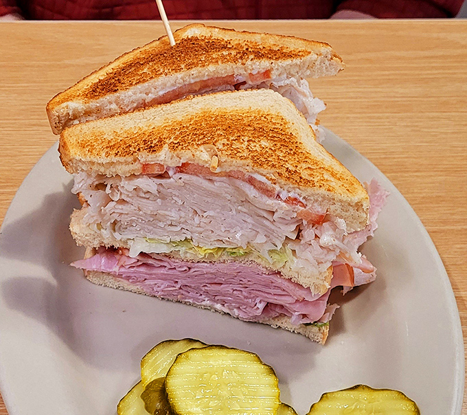 The double-decker sandwich: where excess meets excellence. Three slices of bread creating a skyscraper of deli meat that would make Manhattan architects jealous.