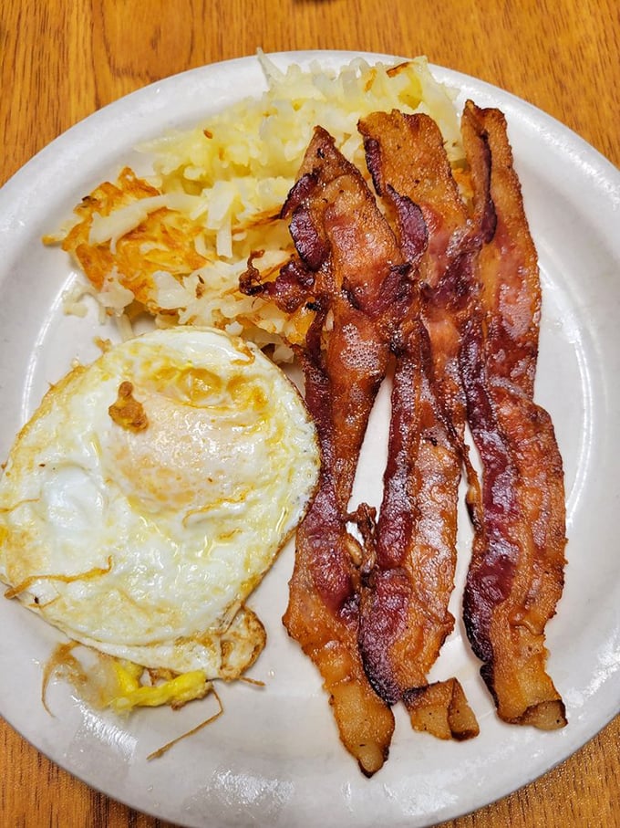 Breakfast perfection doesn't need to be complicated. Crispy bacon, golden hash browns, and a sunny-side-up egg that's basically winking at you.