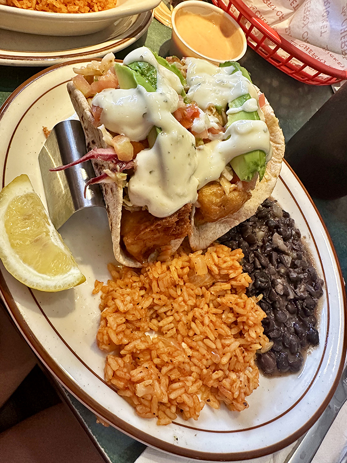 Fish tacos that bring coastal vacation vibes to landlocked Colorado, complete with Spanish rice and black beans that refuse to be mere sidekicks.