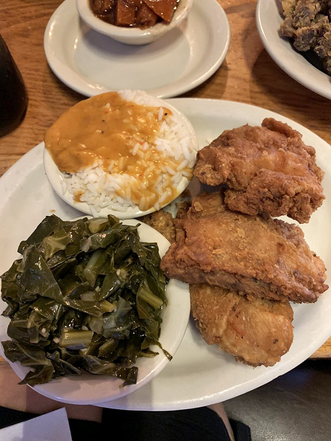 Soul food symphony on a plate. The collard greens, rice, and chicken create a harmony that would make Aretha Franklin herself stand up and applaud.