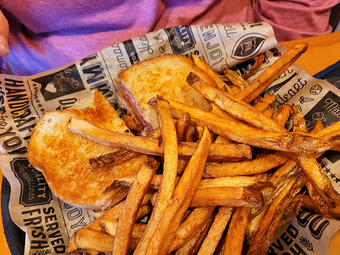Golden fries with that perfect crunch-to-fluff ratio, served on newspaper-lined baskets because some traditions deserve to stay exactly as they are.
