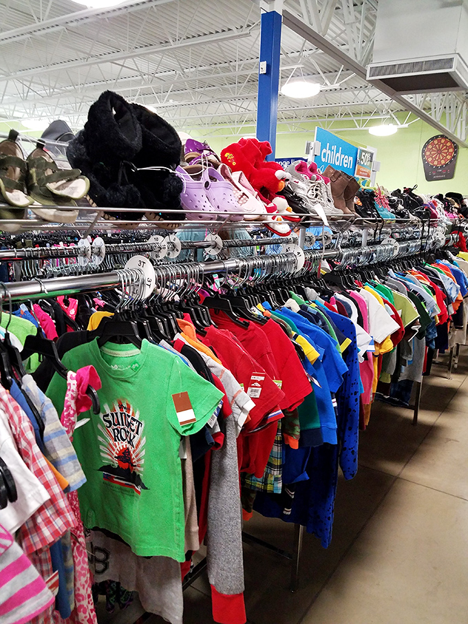 The children's clothing section explodes with color and possibility. Those tiny shoes perched above might outfit an entire kindergarten class.