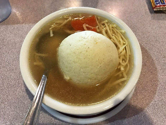 The matzo ball soup – where a cloud-like dumpling floats in golden broth. Grandmothers everywhere would approve.