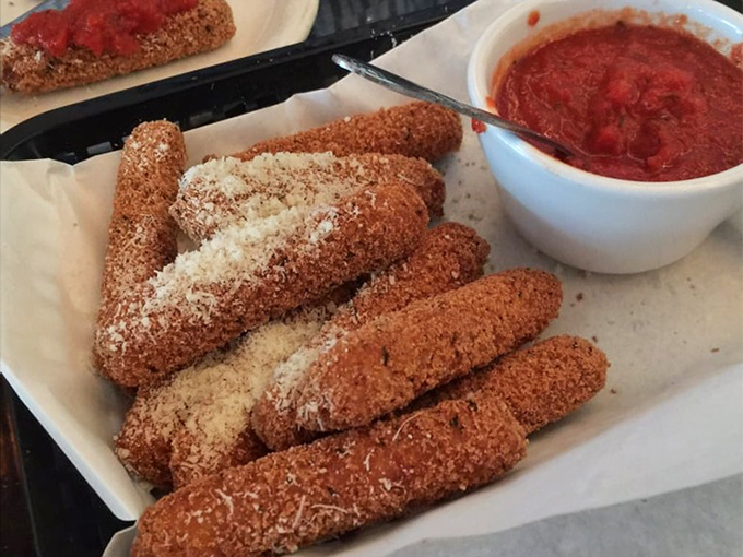 Mozzarella sticks that achieve the golden ratio of crispy exterior to molten interior. Dipped in that house marinara, they're what comfort food dreams are made of.