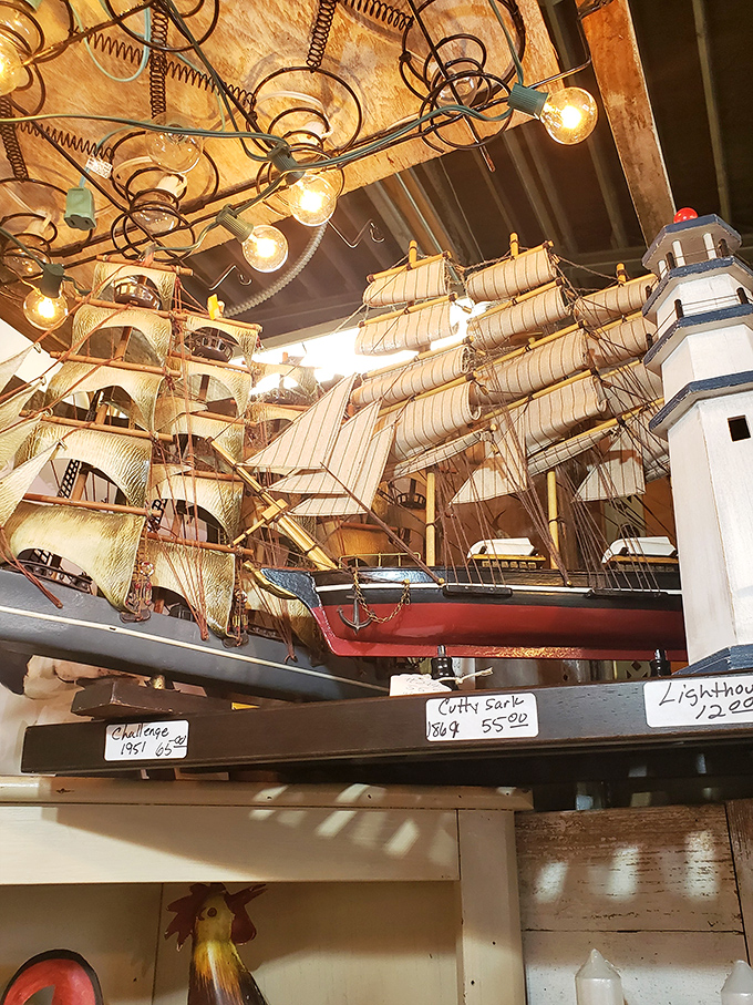 Model ships and lighthouses sail through time under vintage lighting fixtures. Maritime history suspended in a moment of perpetual voyage.