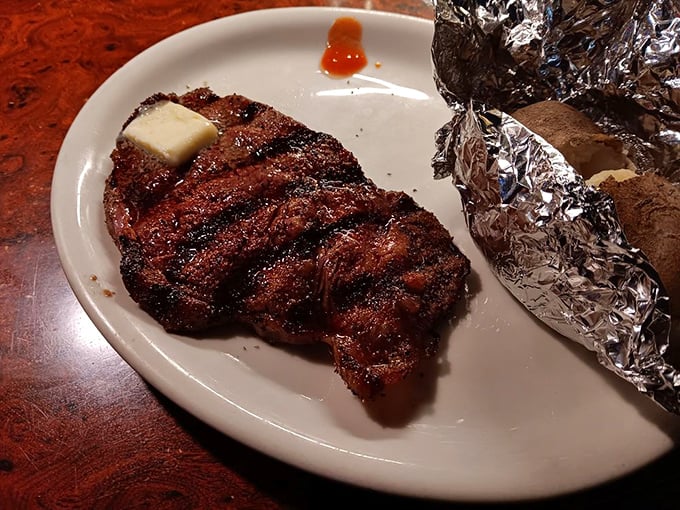 The New York strip arrives with a pat of melting butter, a silent reminder that sometimes the simplest pleasures are the most profound.