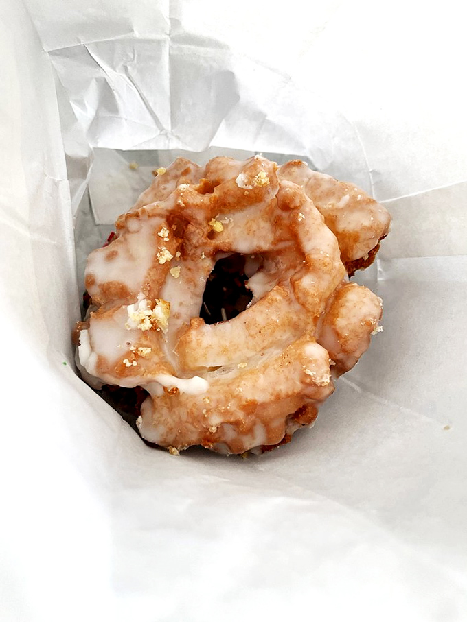 This old-fashioned donut sits pretty in its paper wrapper, ready to transport you to simpler times.