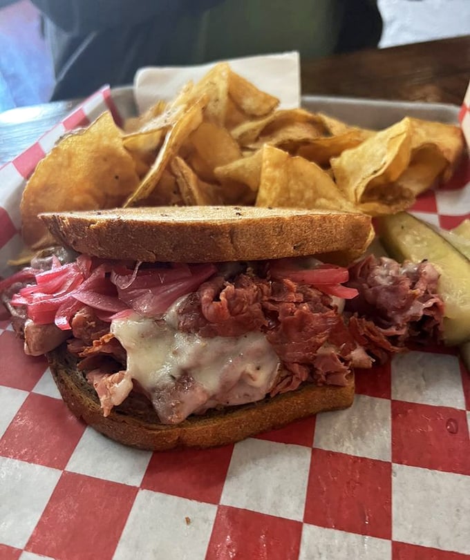This pastrami masterpiece isn't just a sandwich; it's a monument to meat. The pink-hued layers practically whisper "take a bite" from their rye bread home.