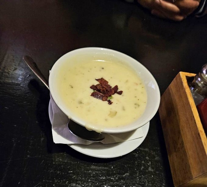 Creamy potato soup topped with crispy bacon bits&mdash;comfort in a bowl. Like a warm hug on a rainy London day, transported to Tennessee.