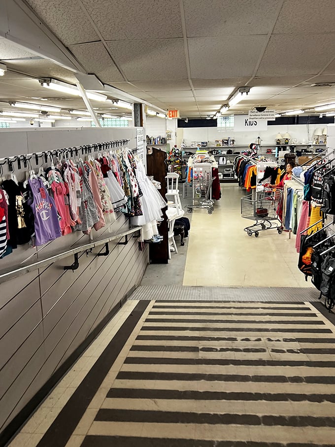 The kids' section ramp&mdash;where tiny formal dresses hang like prom memories waiting for their second chance at magic.
