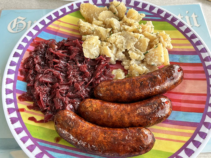 The holy trinity of German comfort: perfectly grilled sausages, tangy red cabbage, and that legendary potato salad. A plate that speaks the international language of delicious.