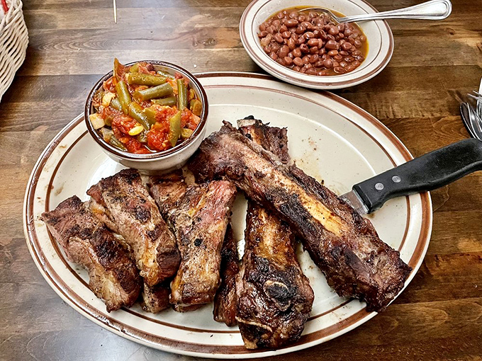 Ribs that fall off the bone like they're eager to meet your taste buds, served with classic sides.