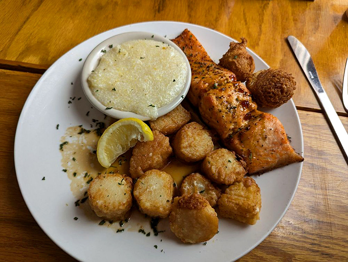 A seafood trifecta that hits all the right notes&mdash;tender salmon, perfectly seared scallops, and creamy grits that would make any Southerner proud.