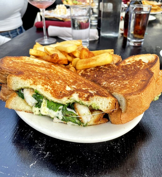 This sandwich towers with the architectural ambition of someone who clearly never heard the phrase "less is more."