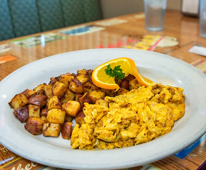 Fluffy scrambled eggs dance alongside seasoned potatoes in this comfort food symphony that never disappoints.