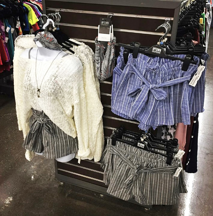 Outfit coordination made easy with these stylish displays. That cream sweater paired with striped shorts is practically begging for a summer adventure.