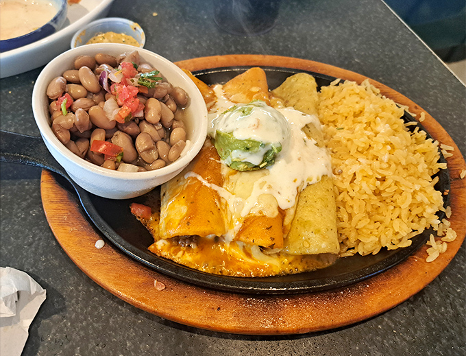 A sizzling enchilada plate that doesn't just satisfy hunger&mdash;it creates memories. That dollop of guacamole is the chef's kiss.