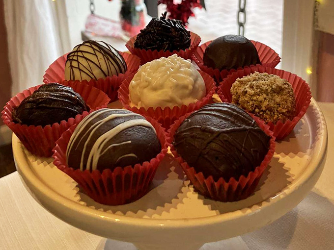 Chocolate truffles arranged like jewels in a display case. Each one promises a moment of pure bliss that melts away the day's troubles.