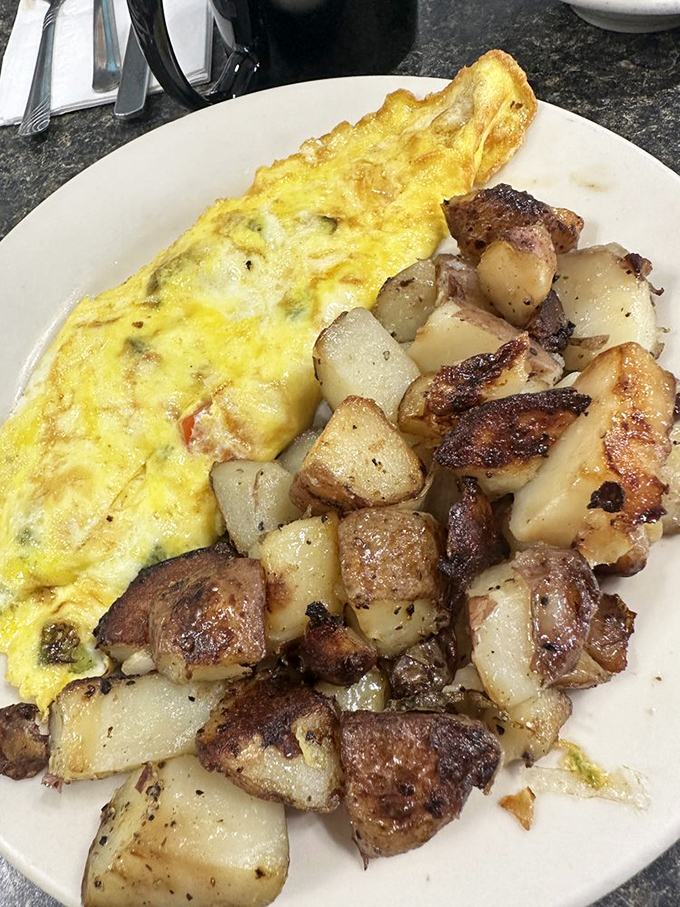 The veggie omelet that ate Manhattan, served with home fries crispy enough to make a potato proud of its afterlife.