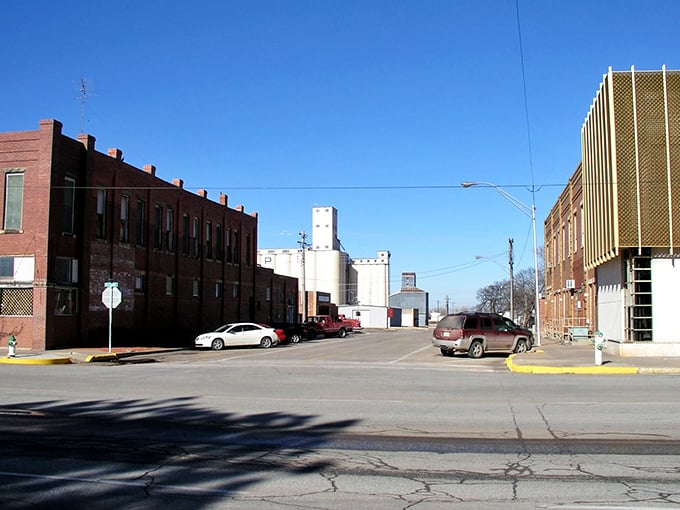 Downtown Alva's historic buildings stand against the backdrop of grain elevators, a visual reminder of the town's agricultural roots.