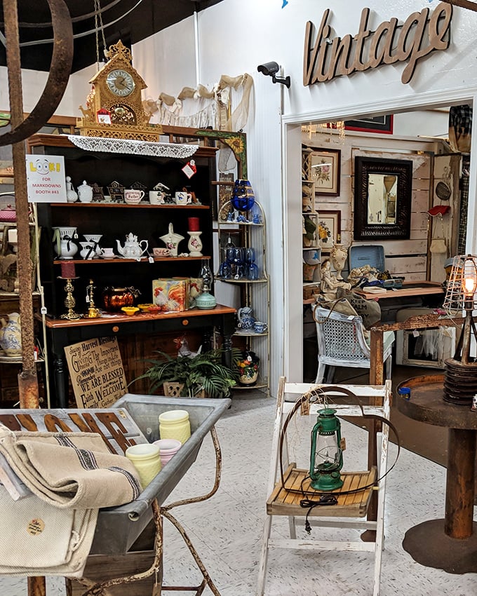 Tea sets, antique clocks, and vintage linens create a perfectly curated corner. That weathered metal chair is practically begging to be taken home and given a second life.