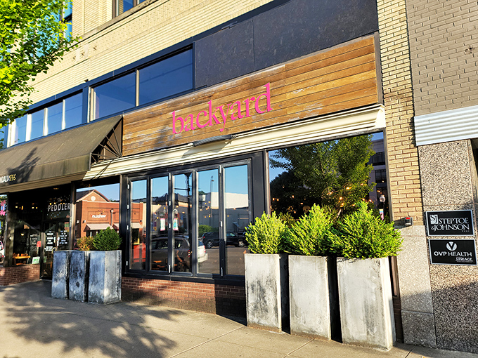 Backyard Pizza's modern wooden facade and pink neon sign hint at the creative pies waiting inside this Huntington hotspot.