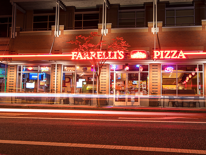 Farrelli's neon sign cuts through the night like a pizza prophet's declaration: "Abandon your diet, all ye who enter here."