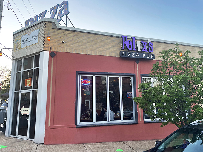 Felix's corner spot glows like a pizza lighthouse, guiding hungry souls to port with its vibrant orange welcome.