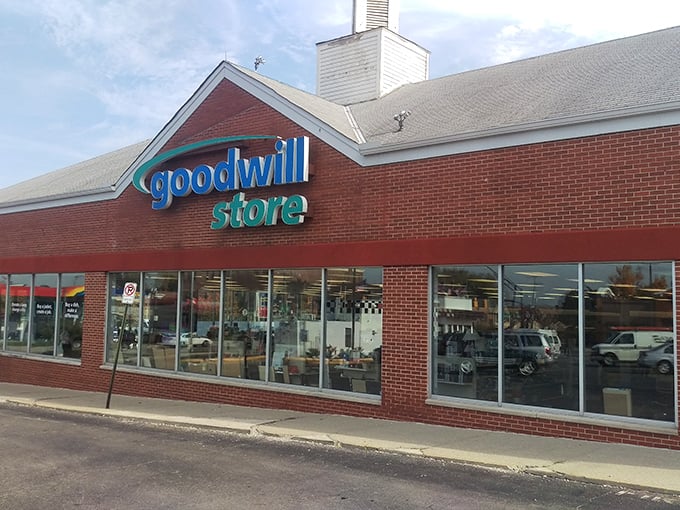 Goodwill's classic blue signage against brick promises a no-nonsense thrifting adventure. Inside, organization meets serendipity in perfect harmony.