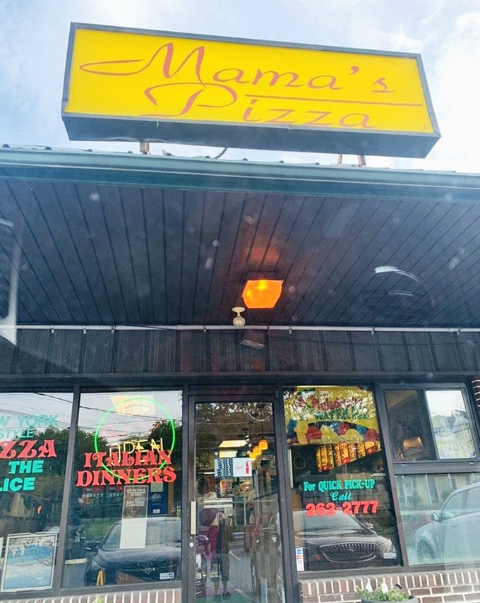 Mama's cheerful yellow sign glowing against the evening sky feels like a warm invitation to pizza paradise.