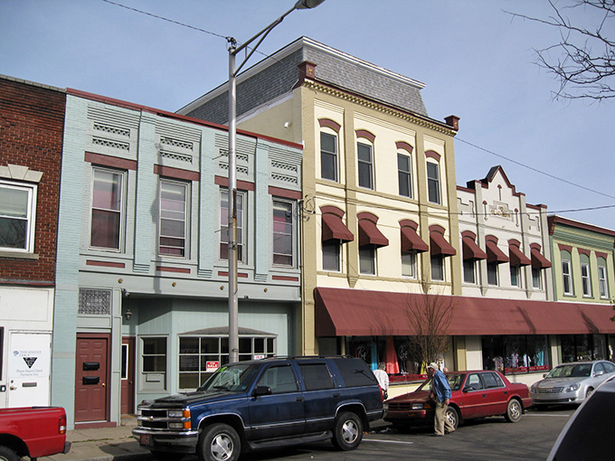 Historic storefronts line Sayre's main street, where colorful awnings and classic architecture create a charming small-town atmosphere perfect for affordable living.