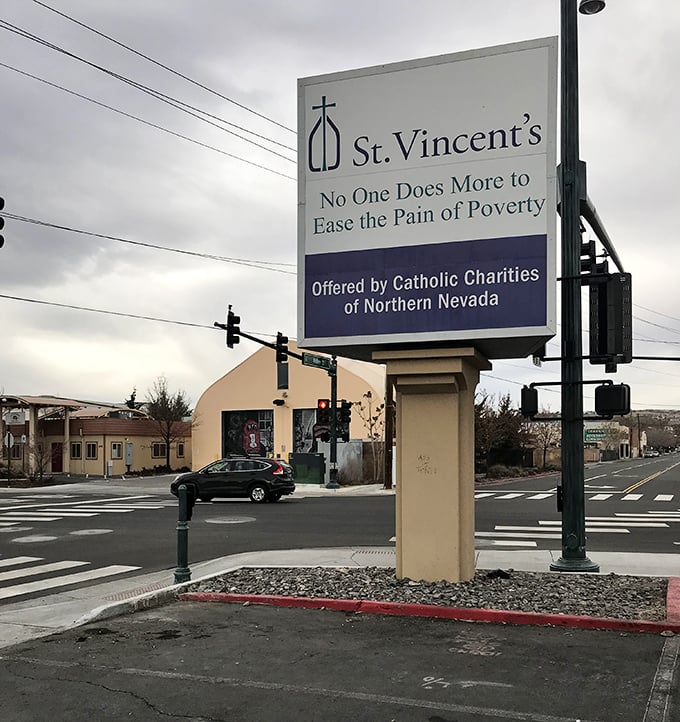 St. Vincent's sign stands tall against the cloudy Nevada sky, promising both bargains and the chance to do good.