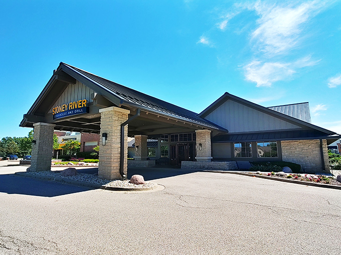 Stone and timber architecture that whispers "serious steaks" before you even smell the wood-fired magic inside.
