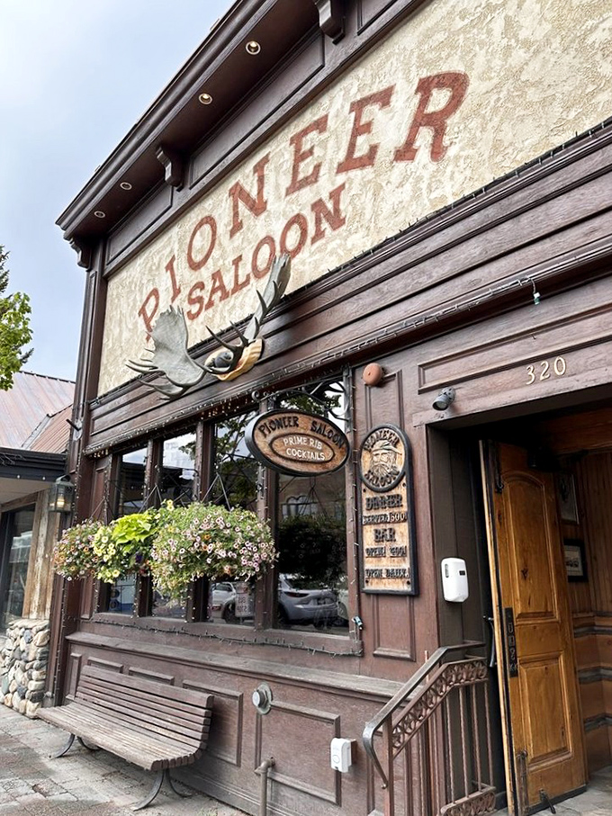 The Pioneer Saloon's weathered facade tells stories of decades serving hungry travelers and local steak enthusiasts.