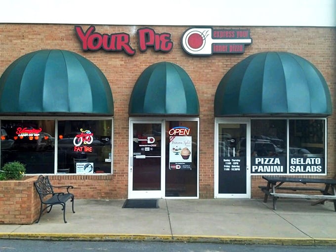 Your Pie's cheery storefront promises personalized pizza perfection. Those green awnings have sheltered many a happy customer.
