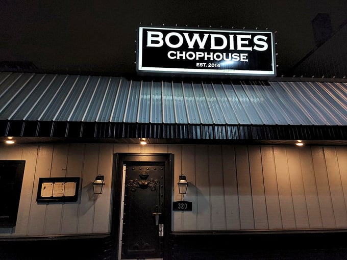 After dark, Bowdie's Chophouse sign glows like a beacon for those seeking premium cuts in Lansing.