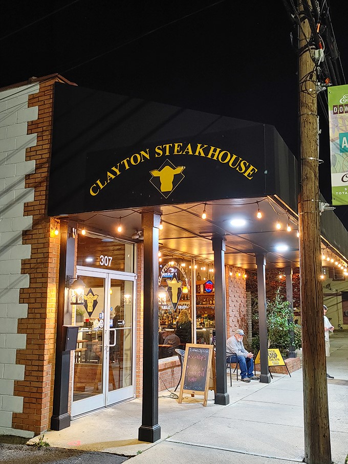 The warm glow of Clayton Steakhouse's evening lights beckons to hungry passersby like a lighthouse guiding ships to safe harbor&mdash;if ships were looking for perfect ribeyes.