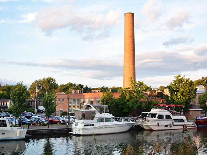 The iconic smokestack stands sentinel over Fairport's waterways, a reminder of industrial heritage in this now-peaceful community.