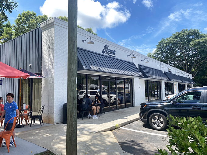 Those cheerful orange tables outside Harry's create the perfect stage for the sandwich performance that's about to unfold.
