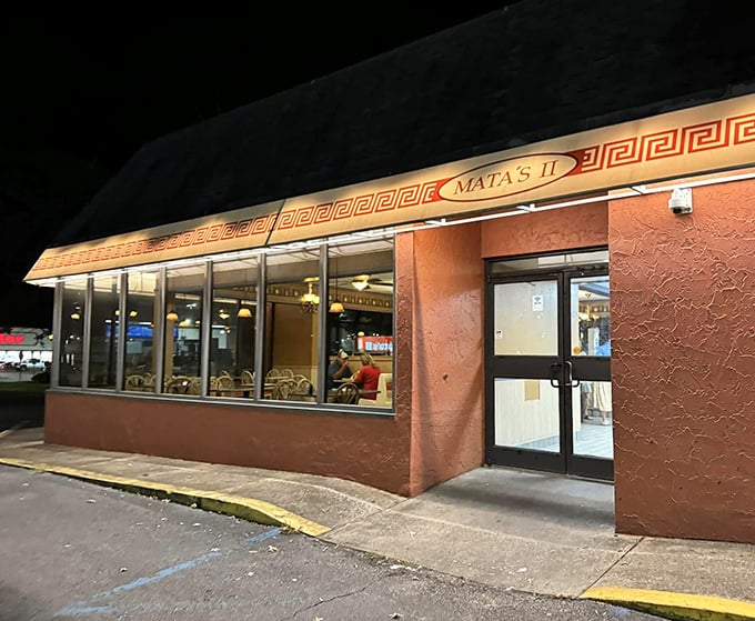 By night, Mata's warm glow transforms this unassuming spot into a beacon for hungry travelers seeking Mediterranean-inspired pizza perfection.