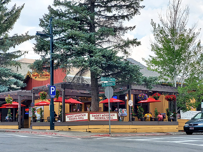 Those red umbrellas and hanging flowers create the kind of place where one slice turns into "maybe we should order another pie."