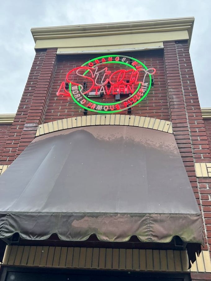 That neon sign isn't just advertising &ndash; it's a pizza lighthouse guiding hungry travelers to thin-crust nirvana in Orange.